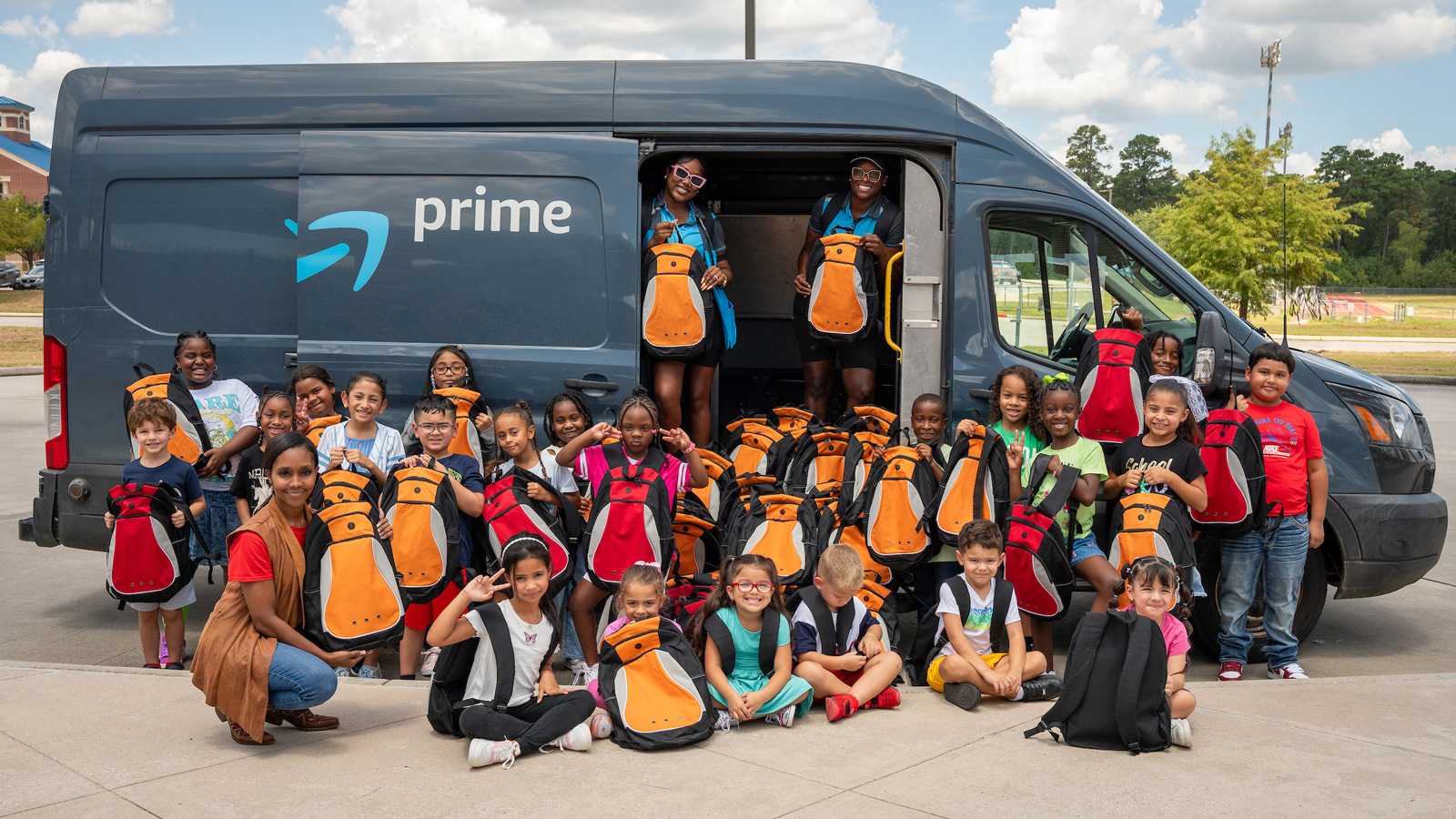 Amazon, One Team Couriers deliver backpacks and smiles to Burchett ES ...
